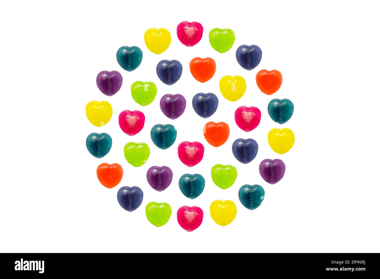 Heart shape confectionery is set in full circle style on white ...