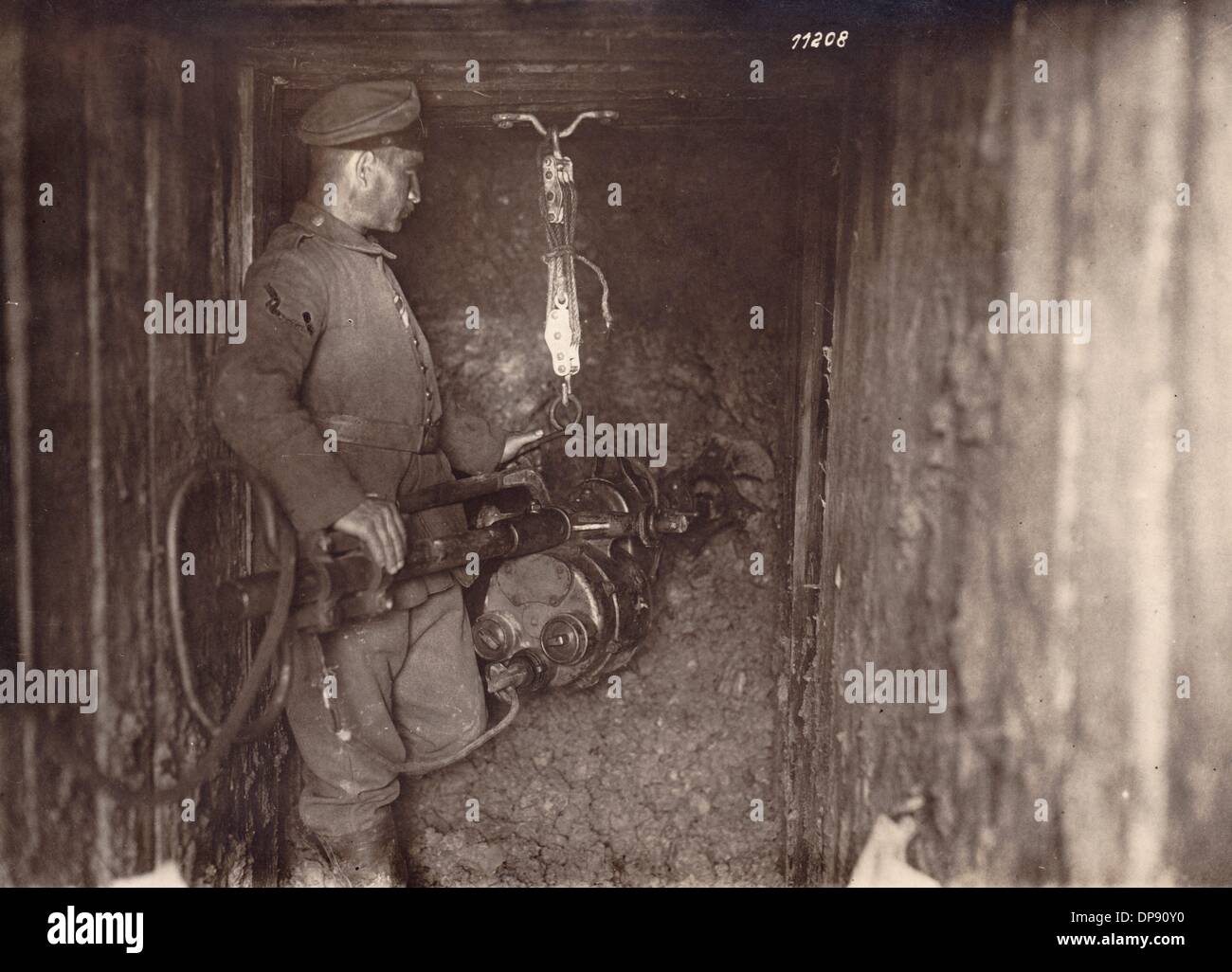 A German soldier works with an electrically powered earth drilling ...