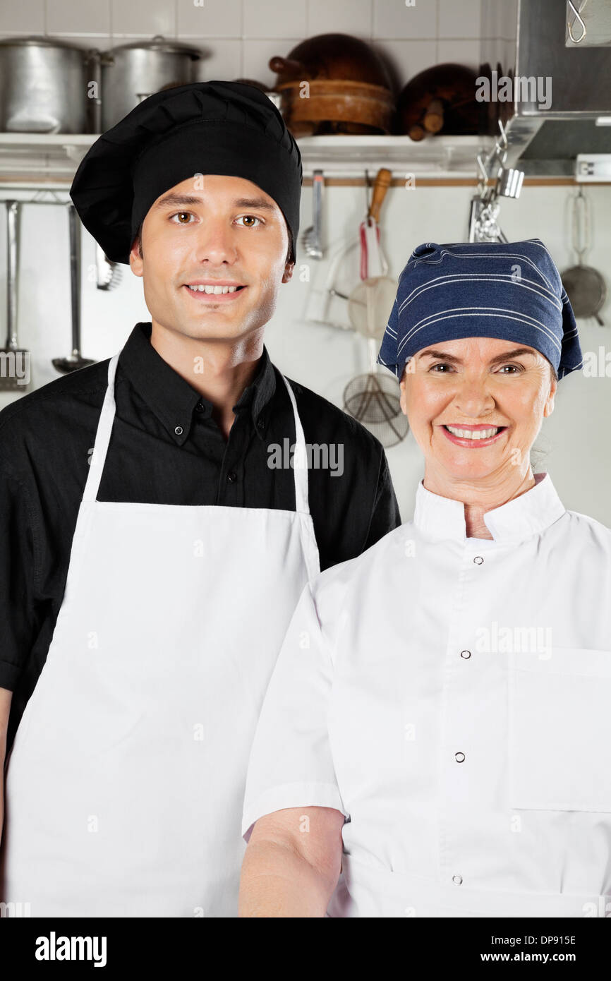 Happy Chefs In Industrial Kitchen Stock Photo - Alamy