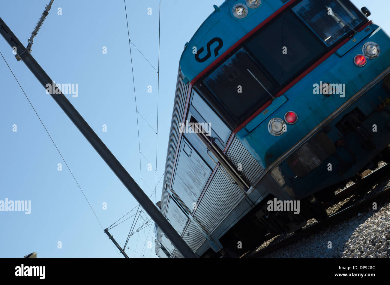 A moving blue train agains ablue sky Stock Photo - Alamy