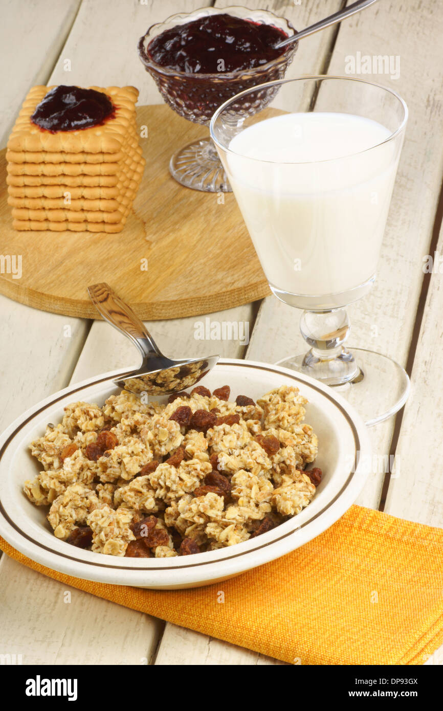 Healthy breakfast with a bowl of crunchy oat clusters with raisins, a ...