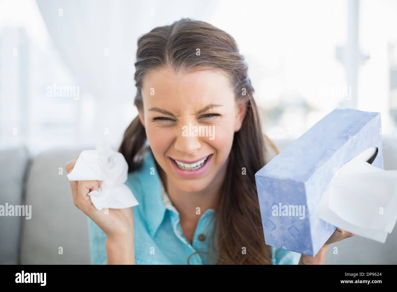 Sad young woman crying sitting on sofa Stock Photo - Alamy