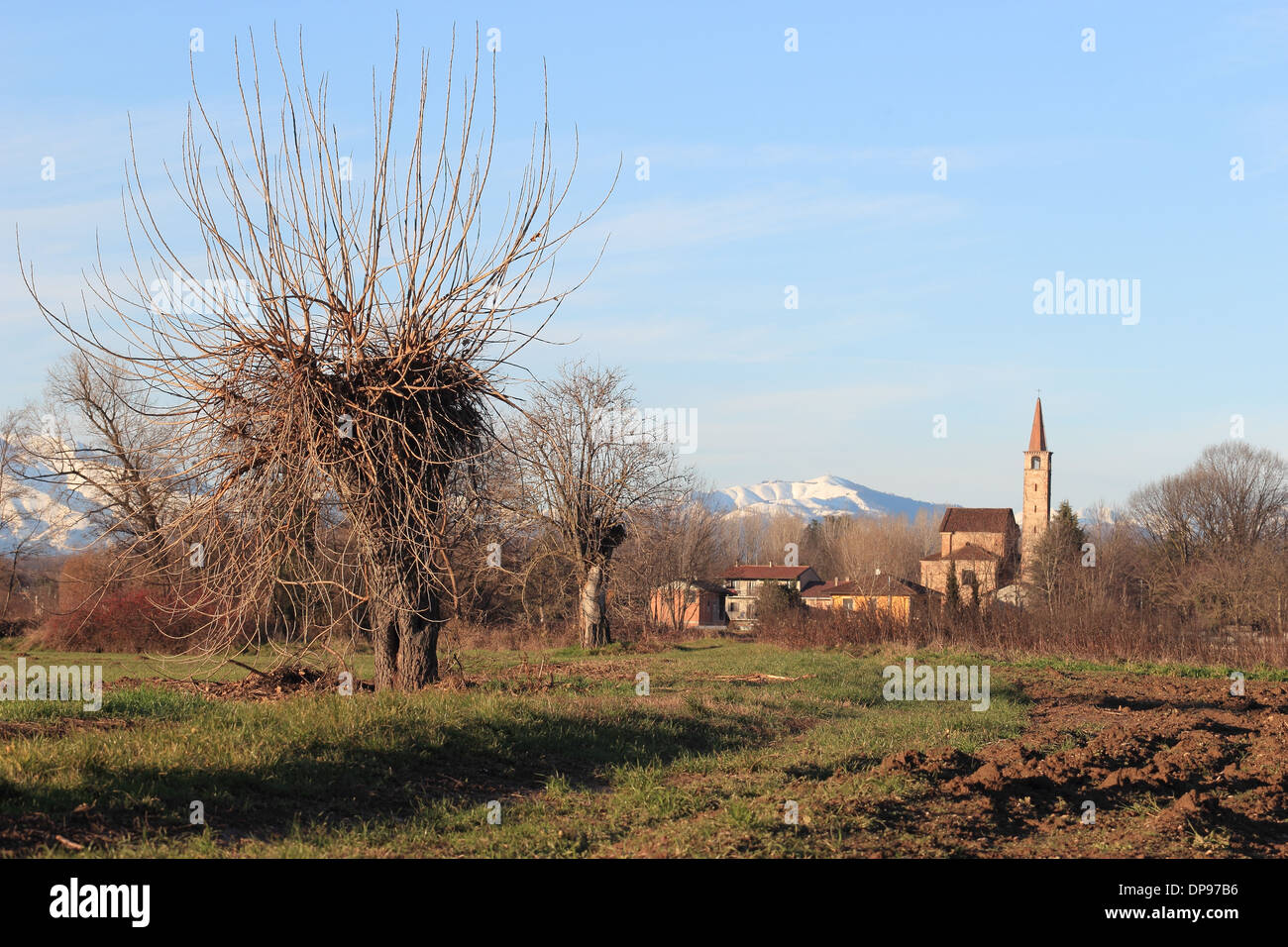 rural landscape with an ancient church (Pieve di Suno) and ski resort ...