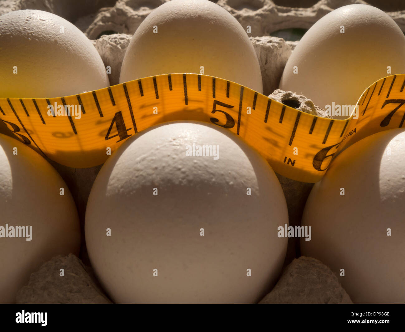 eggs in carton with measuring tape Stock Photo - Alamy