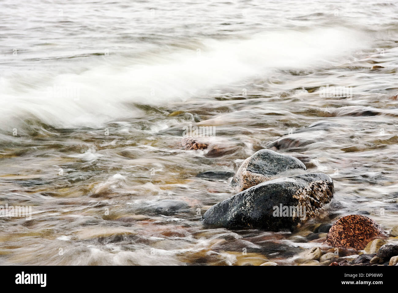 Picture with painting effect of wet rocks in sea with white waves Stock ...