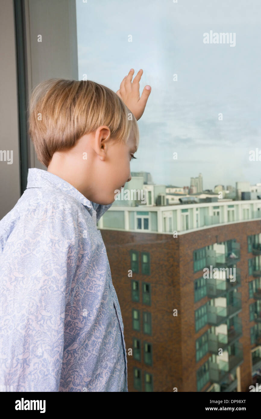 Boy looking through window hi-res stock photography and images - Alamy