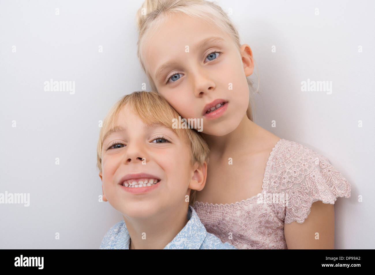 Portrait of brother and sister over gray background Stock Photo - Alamy