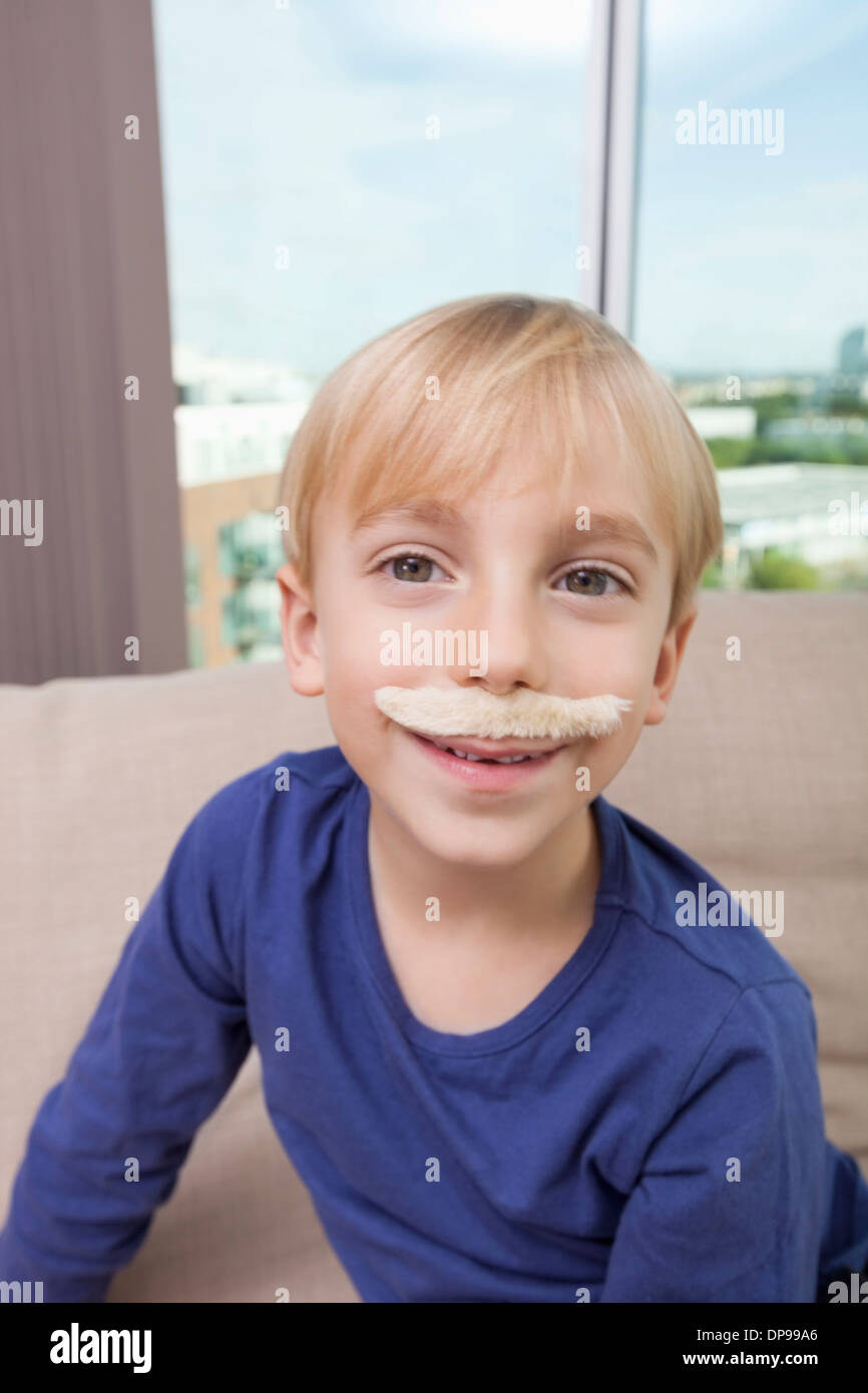 Little boy with artificial mustache smiling Stock Photo - Alamy