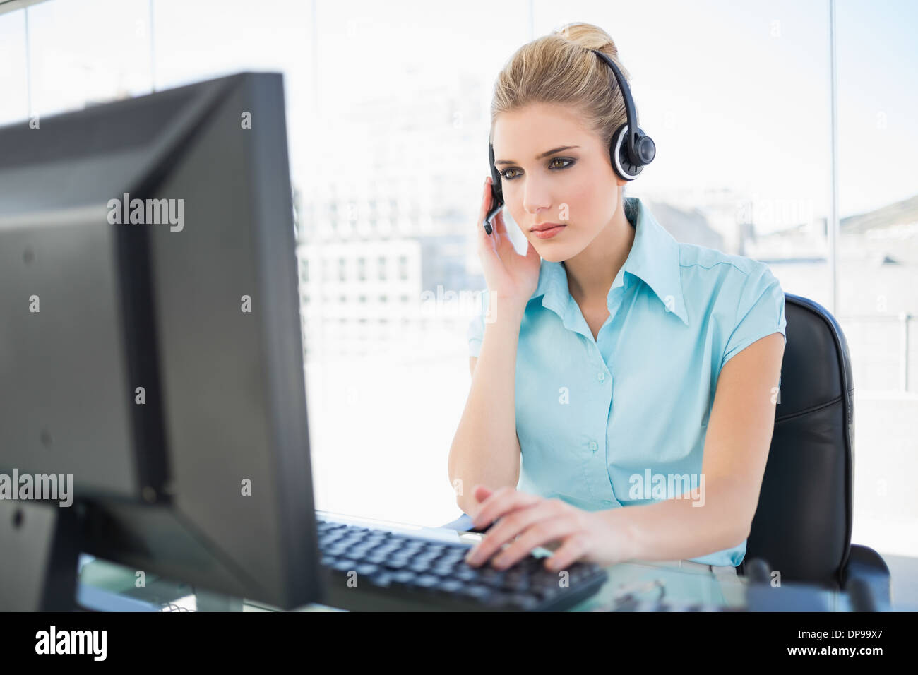 Concentrated call centre agent working on computer Stock Photo - Alamy