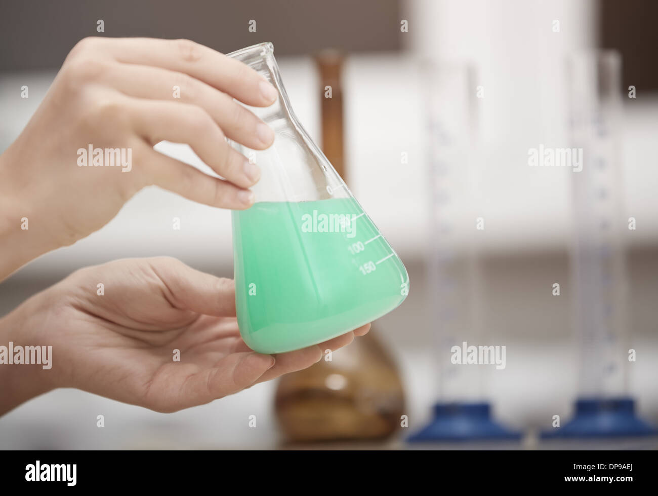 Hand of laboratory technician holding flask with chemical Stock Photo ...