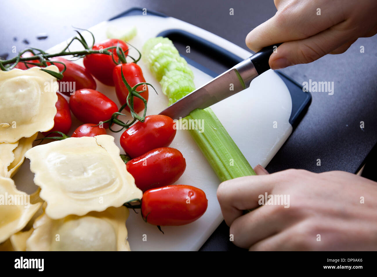 Woman's hand chopping cucumber at kitchen counter Stock Photo - Alamy