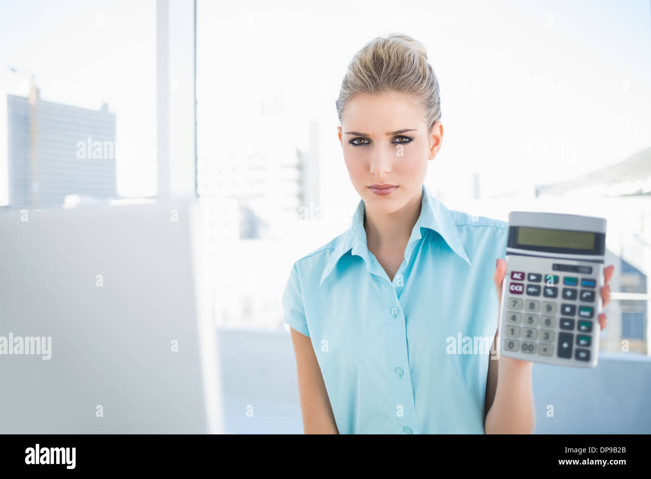 Woman with calculator hi-res stock photography and images - Alamy