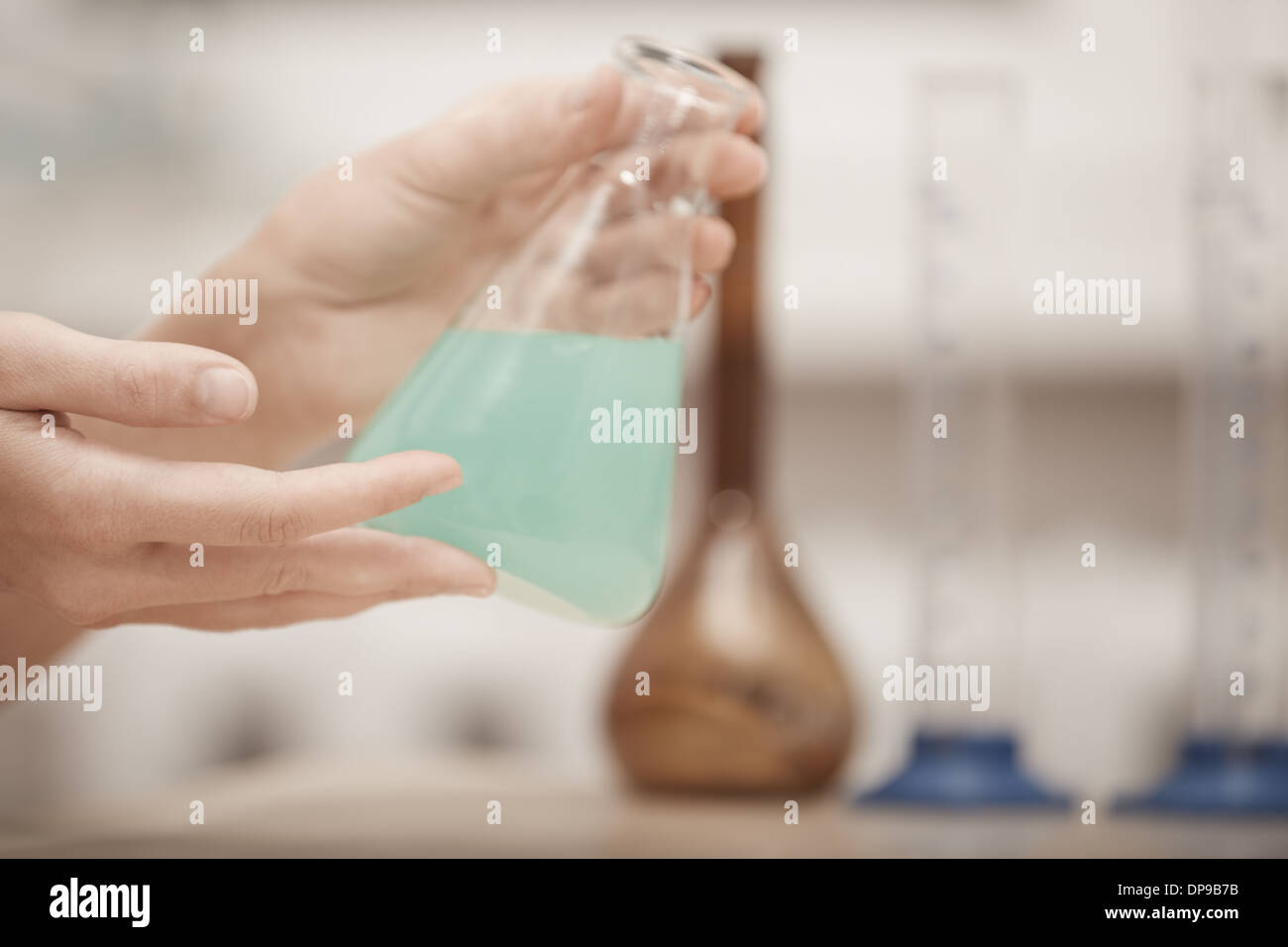 Hand of laboratory technician holding flask with chemical Stock Photo ...
