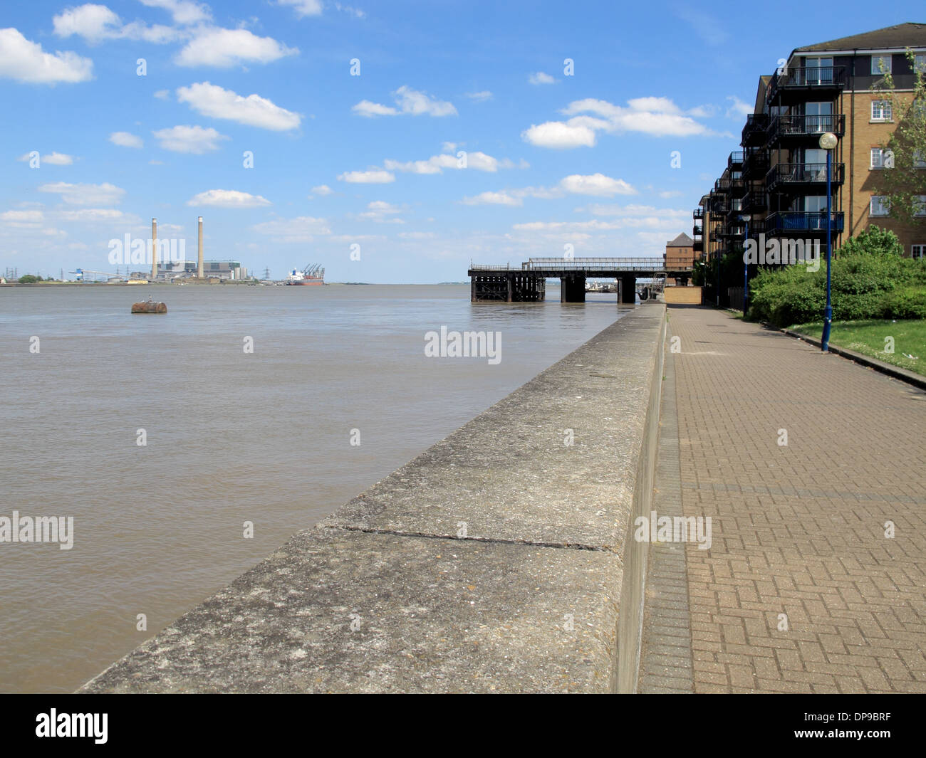 An image showing a walk way by the Riverside with factories in the ...