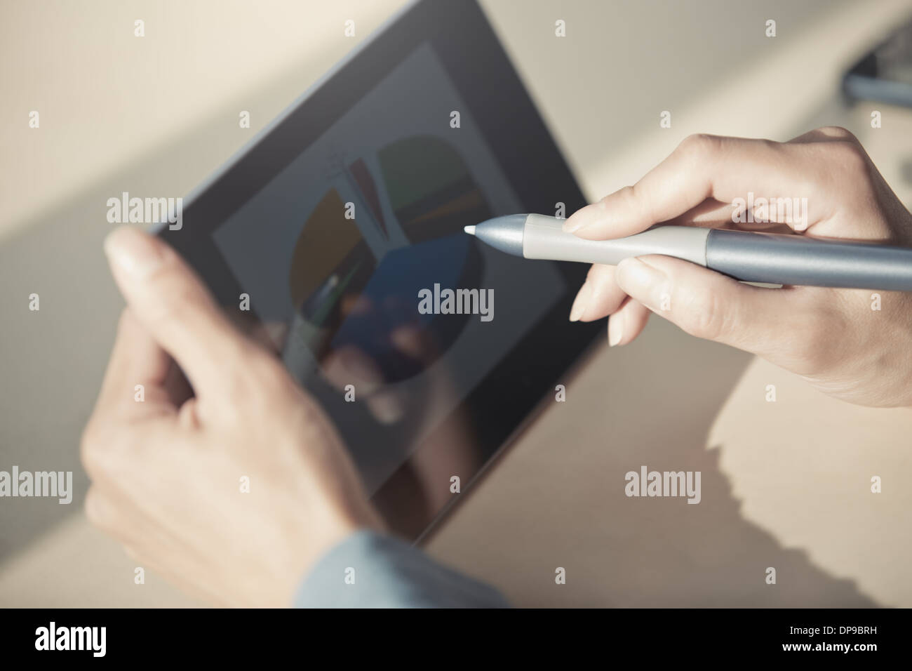 Human hands using tablet PC and stylus for diagram working. Diagram was ...