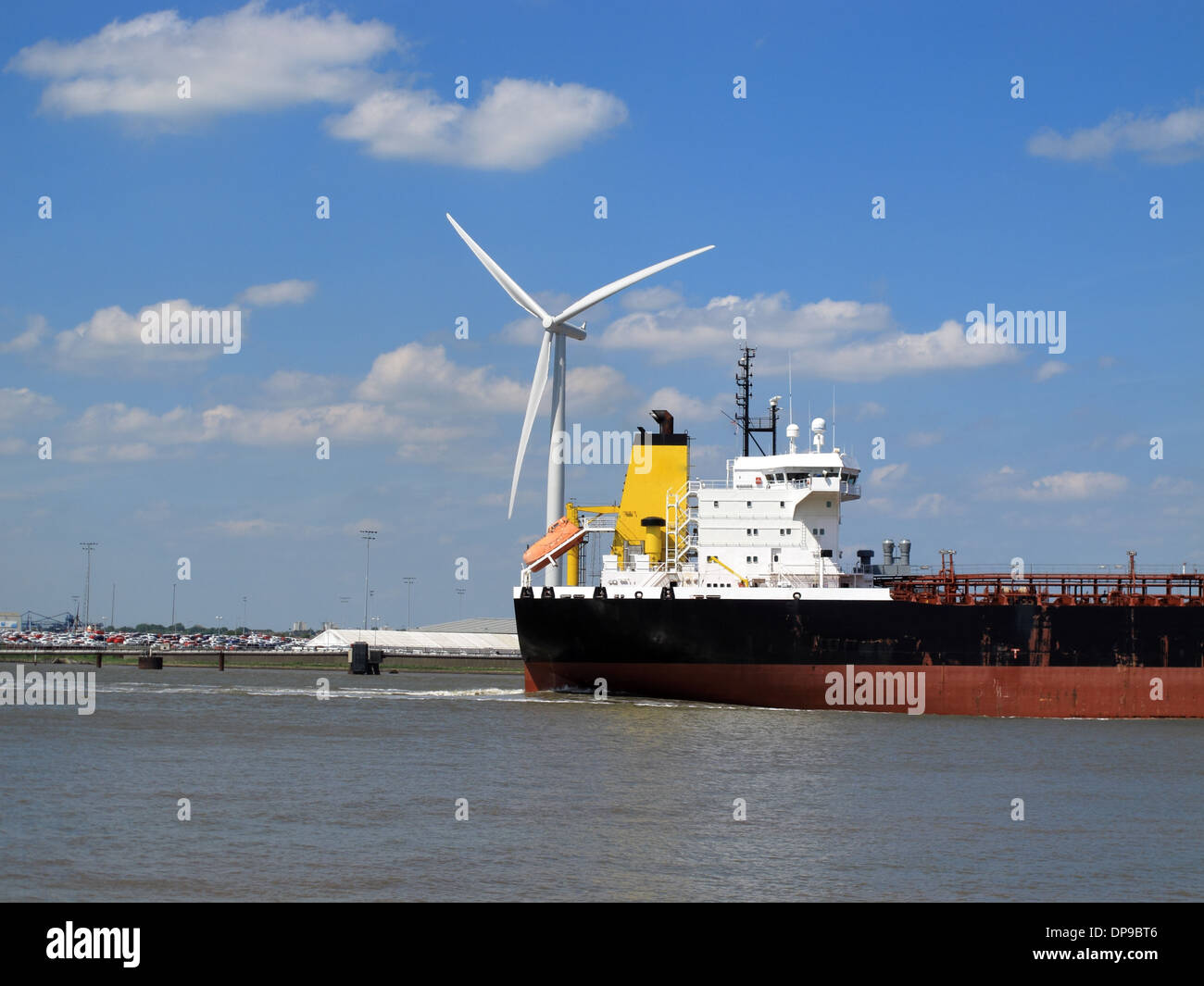 An image of a boat Passing by the wind generator on a river Stock Photo ...