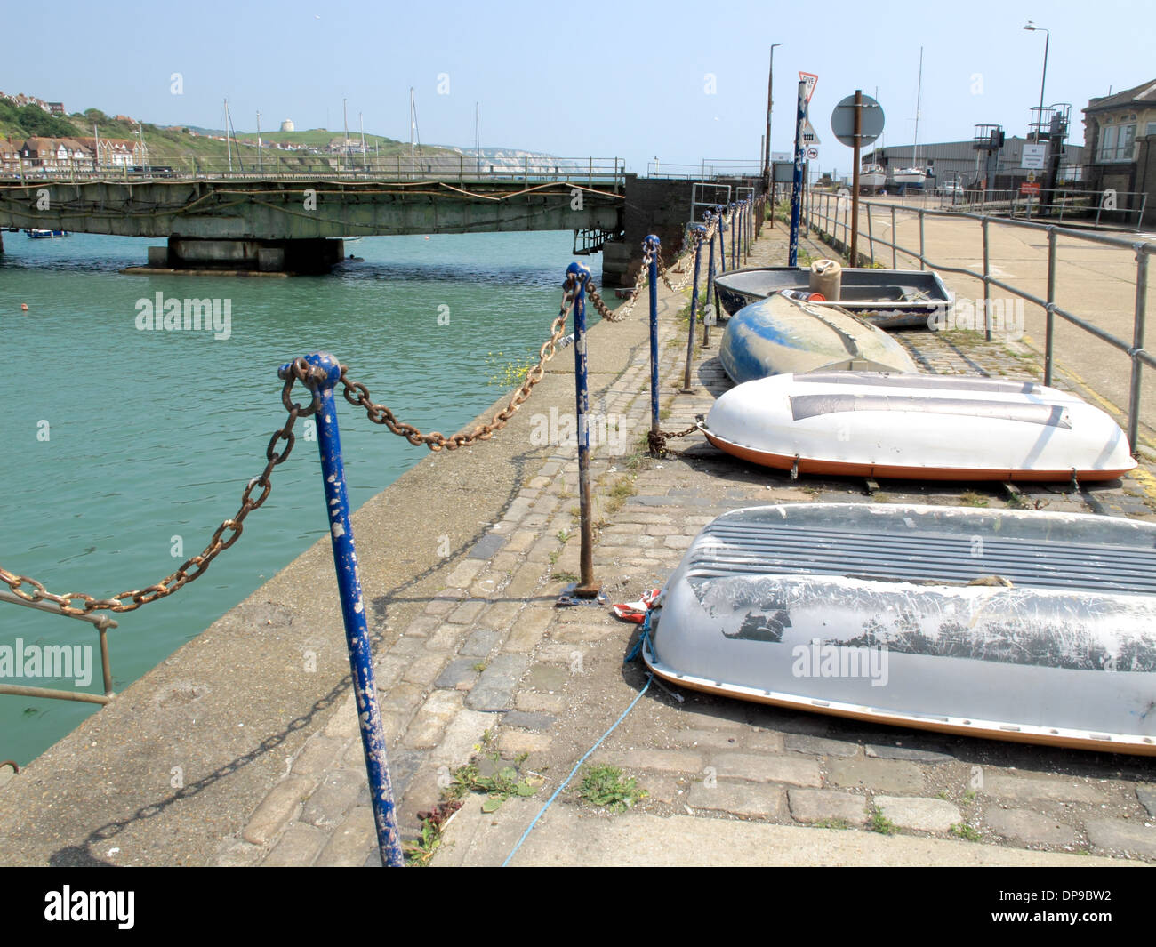 A landscape view showing the old boats and a bridge at Folkestone ...