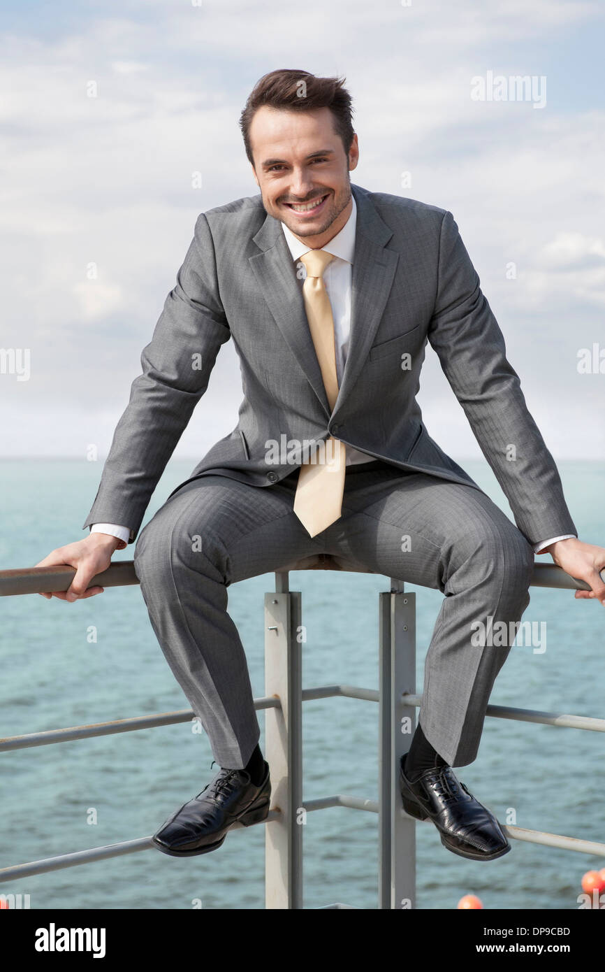 Portrait man sitting on railing hi-res stock photography and images - Alamy