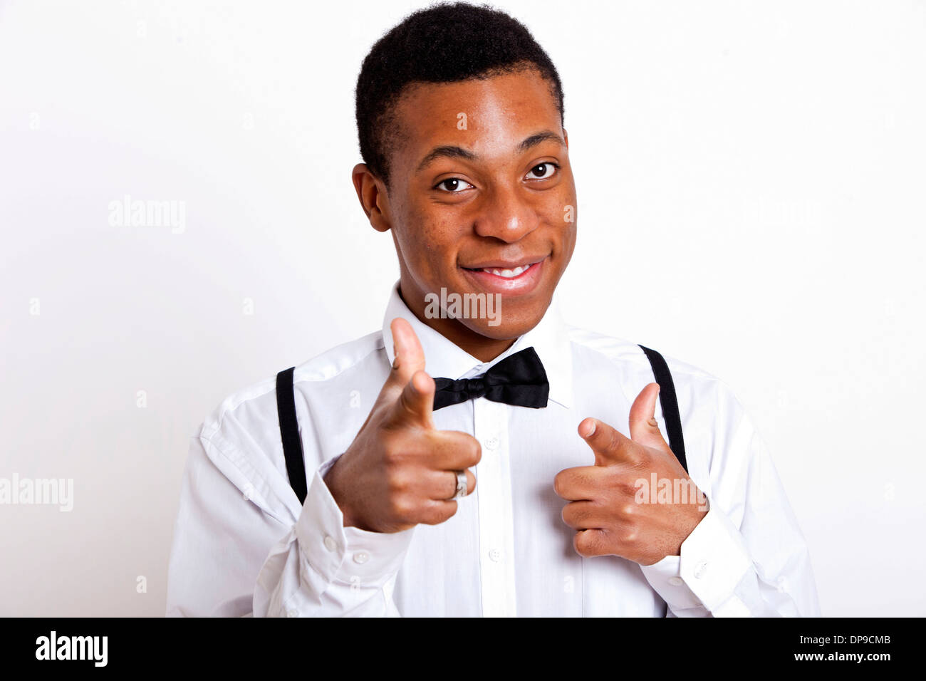 Portrait of young man pointing over white background Stock Photo - Alamy