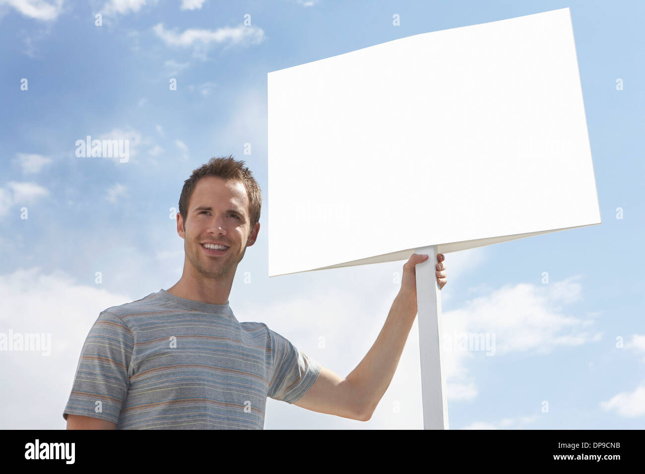 Man standing holding sign hi-res stock photography and images - Alamy