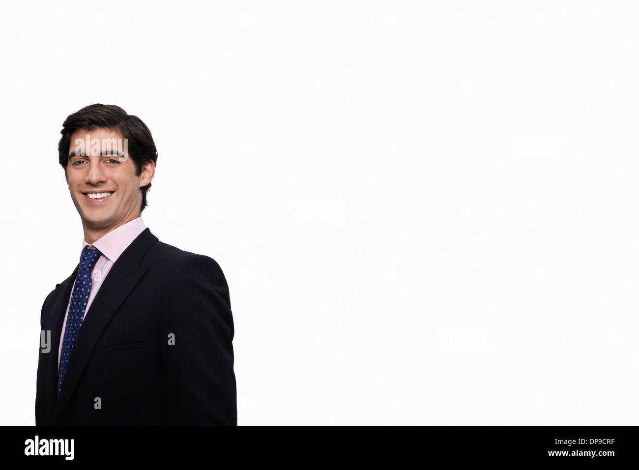 Portrait of happy young businessman against white background Stock ...