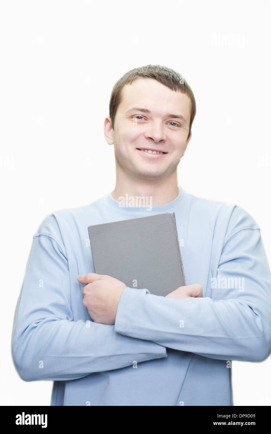 Portrait of young man with book against white background Stock Photo ...