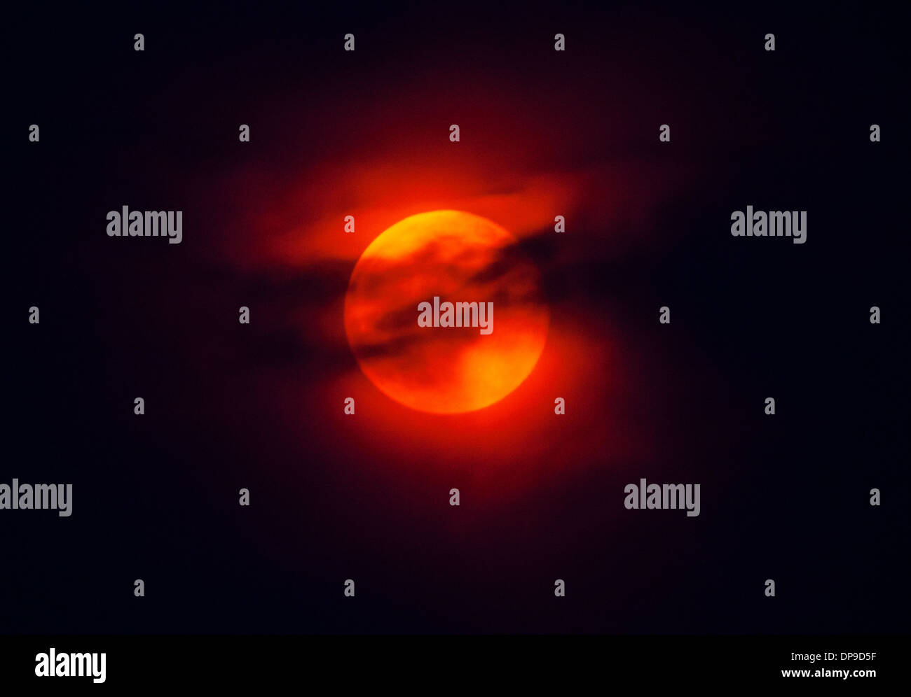 Smoke from forest fires creates an unusual eerie orange glow to the ...
