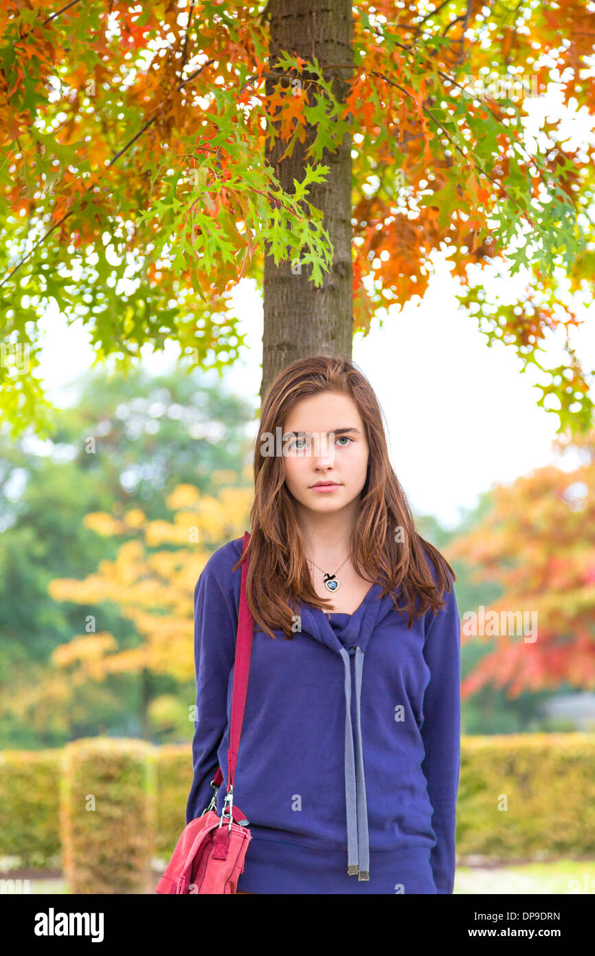 portrait of a female teenager standing under a autumn tree Stock Photo ...