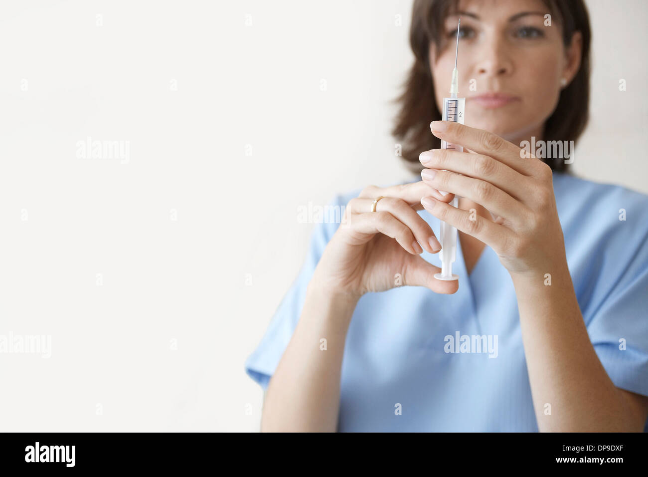 Nurse Preparing syringe For Injection focus on syringe Stock Photo - Alamy