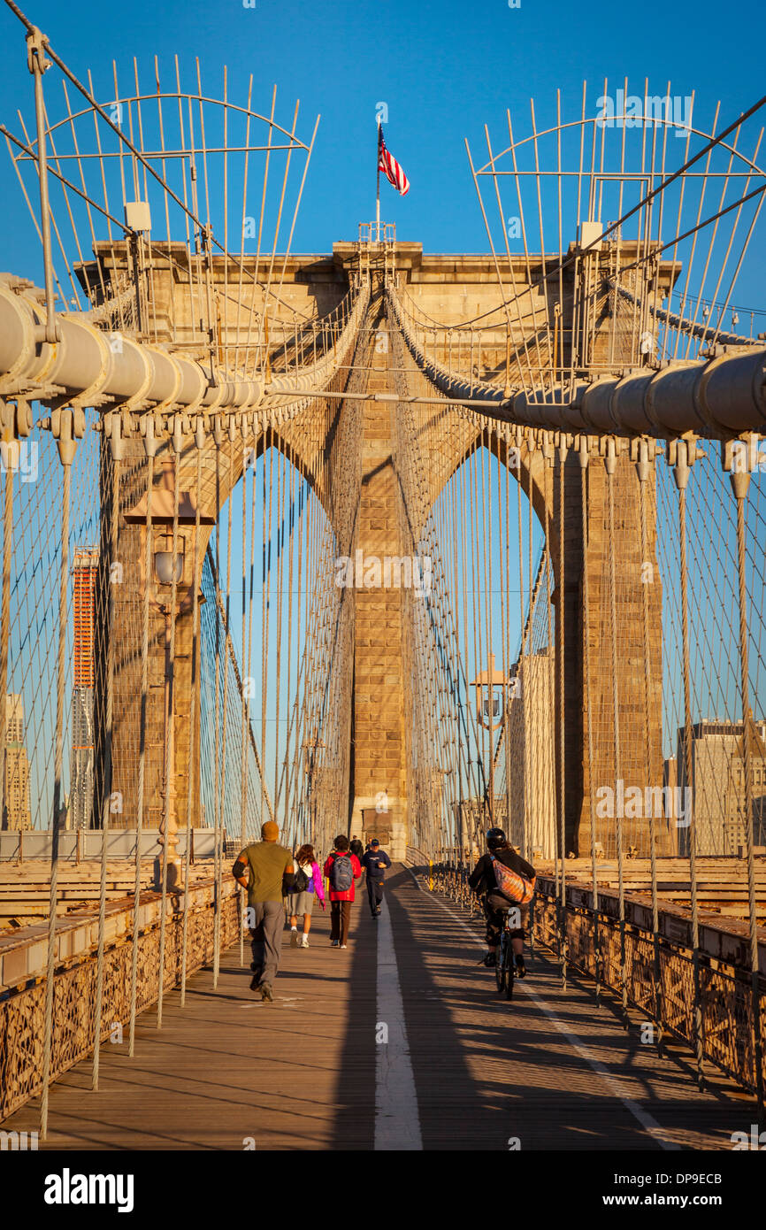 Pedestrian pathway along the Brooklyn Bridge with the buildings of the ...