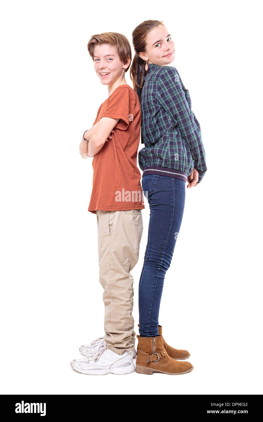 smiling brother and sister compare their size, isolated on white Stock ...