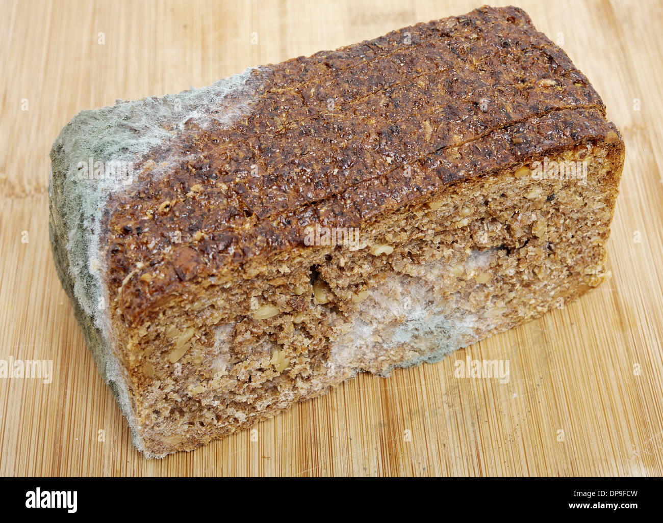 A quarter of wholemeal bread moldy on board Stock Photo - Alamy