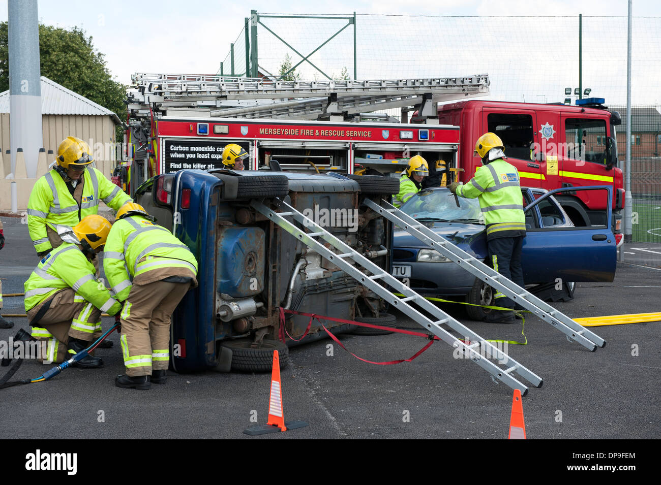 Firefighters stabilising car on side RTA RTC SIMULATION Stock Photo - Alamy