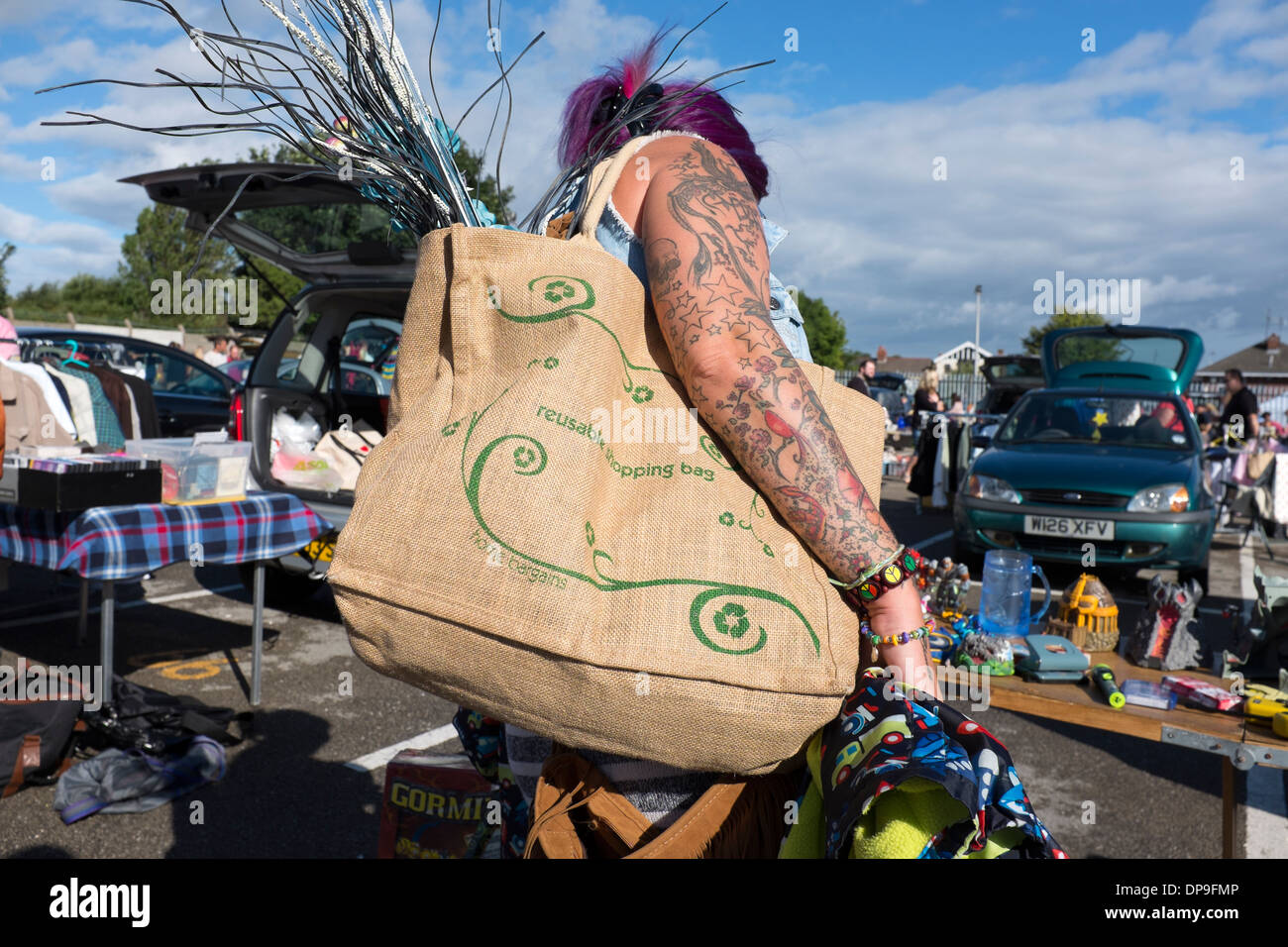Woman with tattoo on arm at car boot sale Stock Photo - Alamy