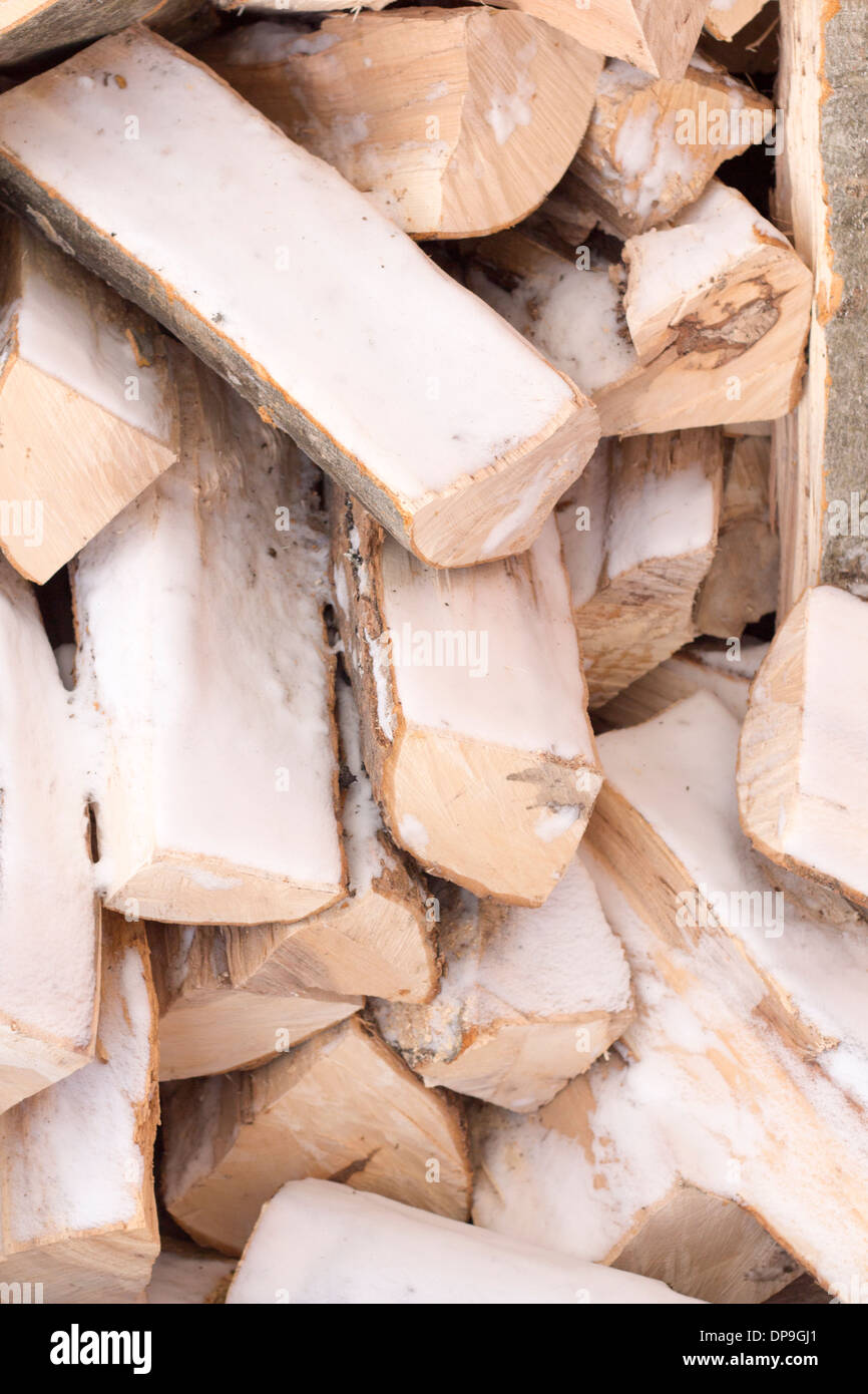 Stack of firewood covered in snow Stock Photo - Alamy