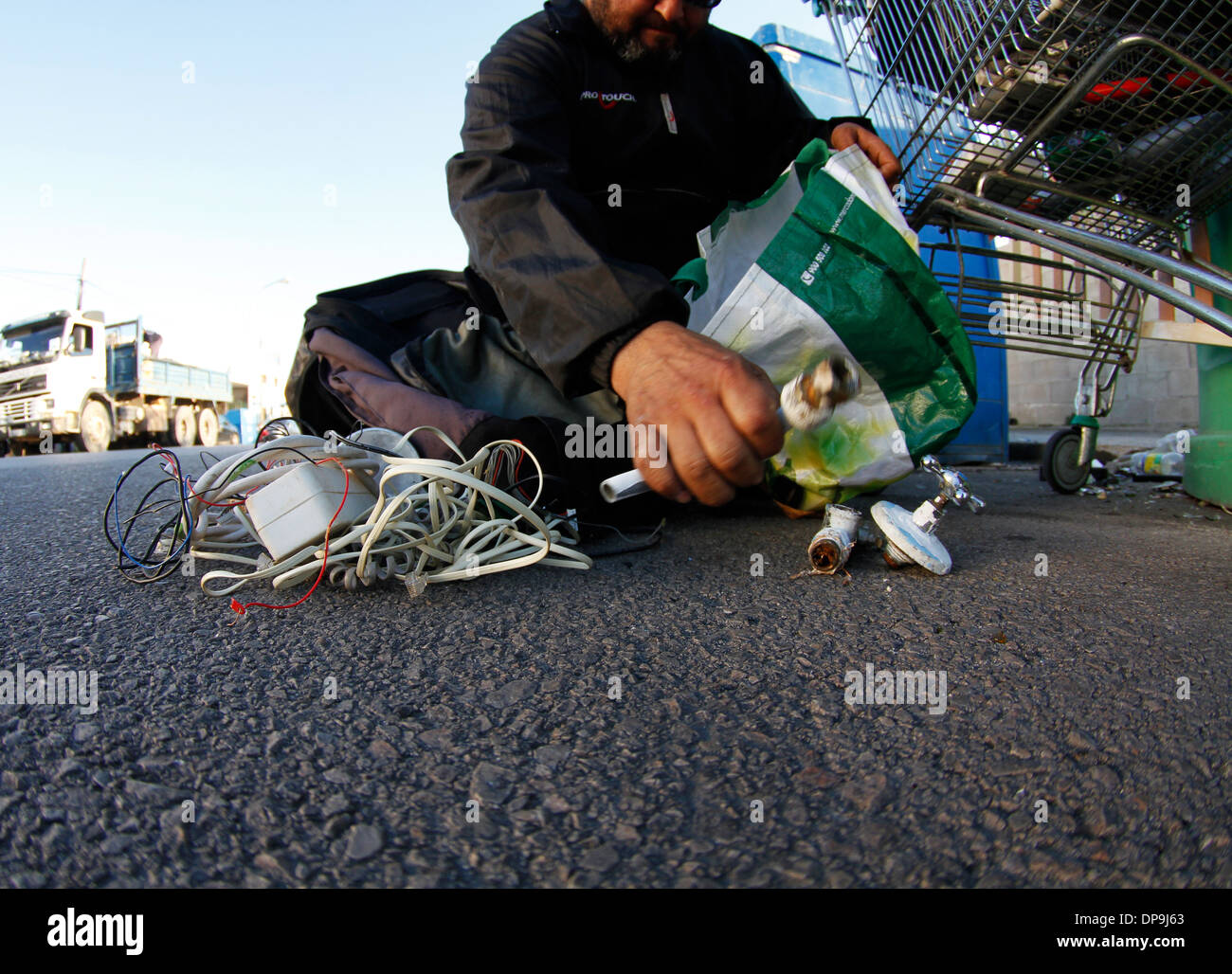 A junkman pushes his trolley where he picks between the junk copper ...