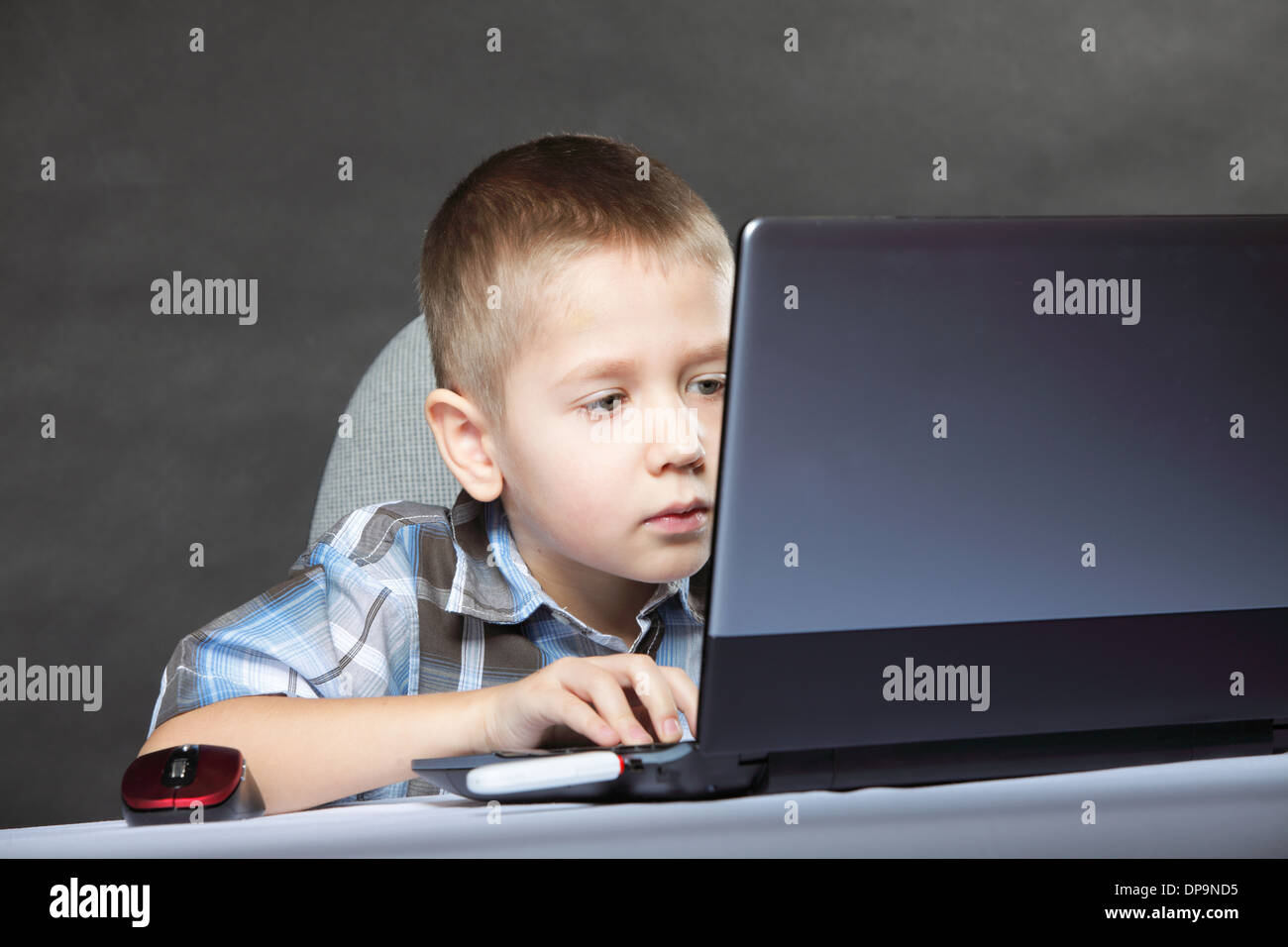 Computer addiction child boy with laptop notebook black background ...