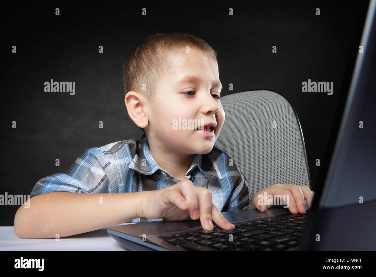 Computer addiction child boy with laptop notebook black background ...