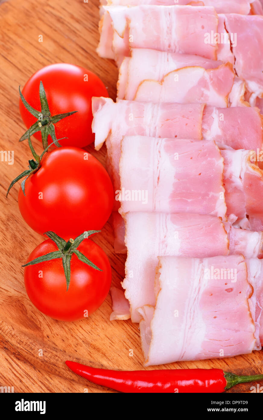 Red meat bacon rolled with tomato and pepper Stock Photo - Alamy