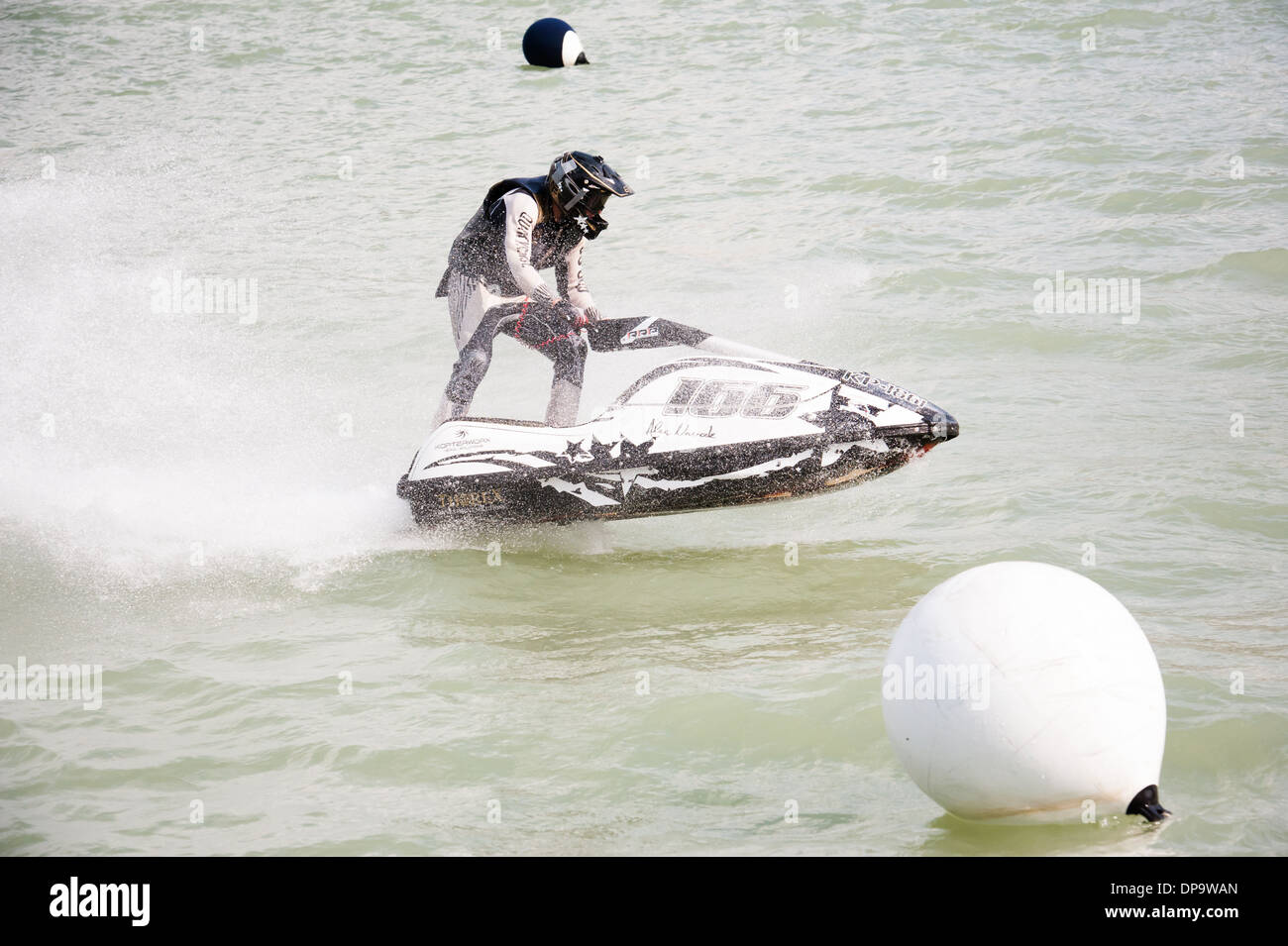 Jet ski contestant with a helmet riding a jet ski contest on the river ...