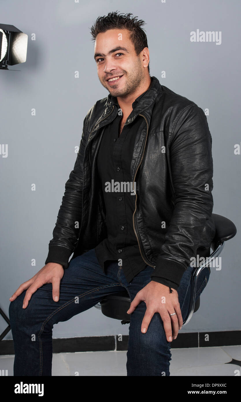 Portrait studio photo shoot of egyptian male man isolated on a blue ...