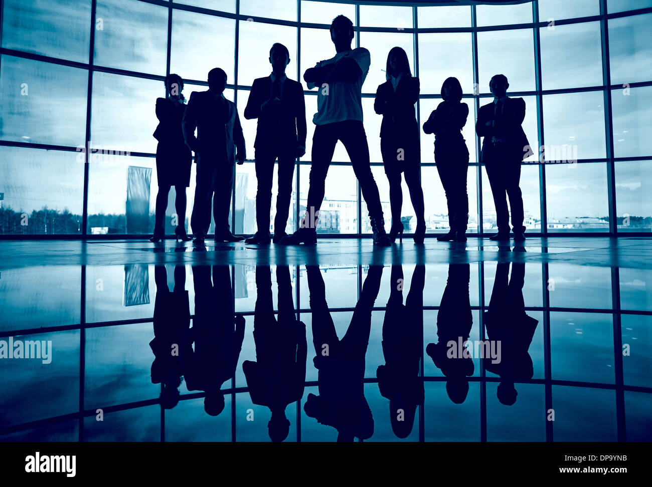 Business team standing against window with leader in front Stock Photo ...