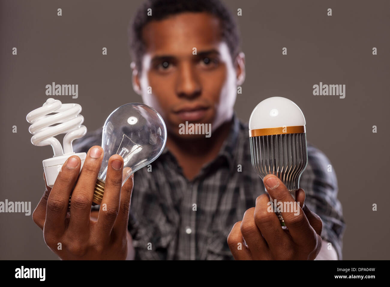 man holding two old and the newest generation of light bulbs Stock ...