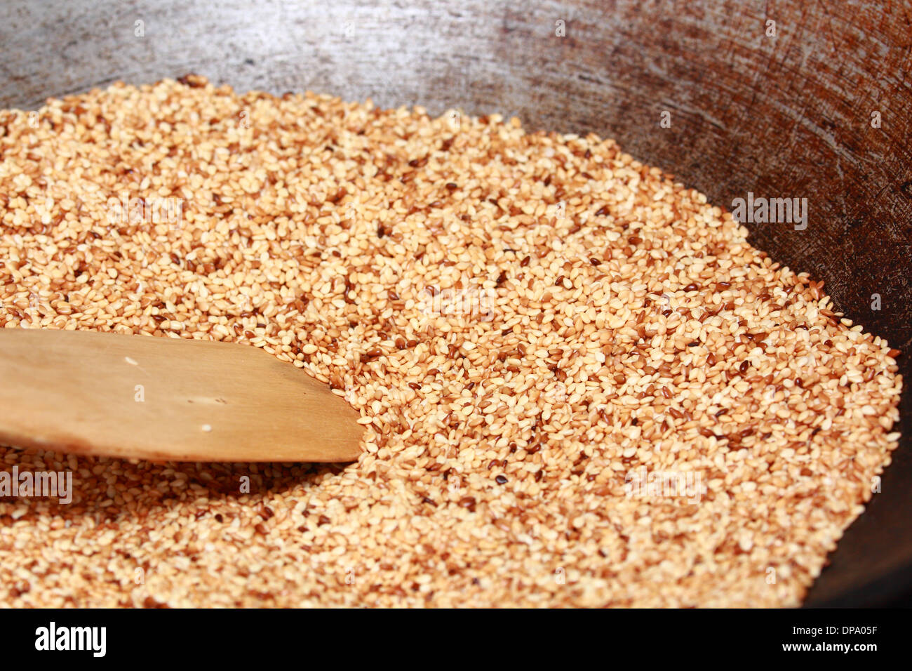 sesame roast dry on pan with wood scoop close up Stock Photo - Alamy