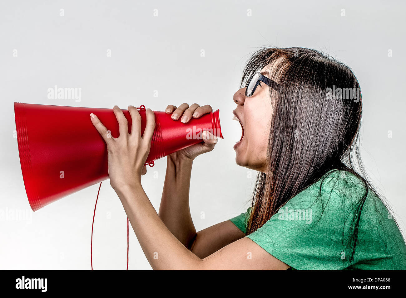 asian woman yelling shooting in studio Stock Photo - Alamy