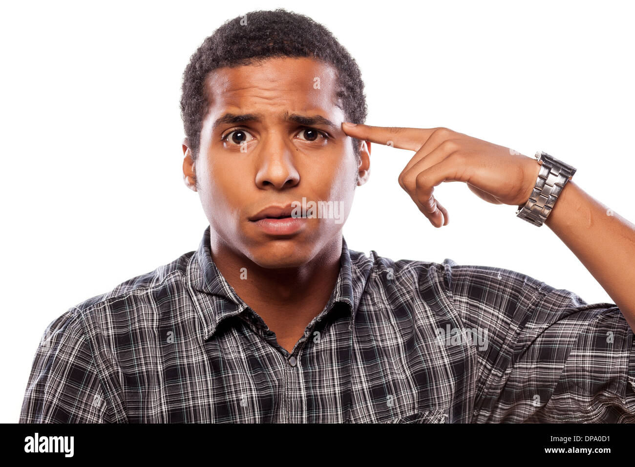 dark-skinned young man thinks with his finger on the head on white ...