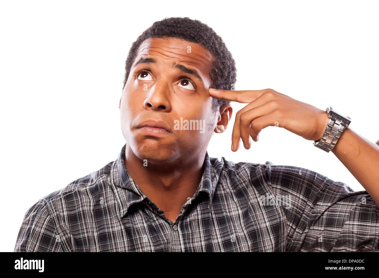 dark-skinned young man thinks with his finger on the head on white ...