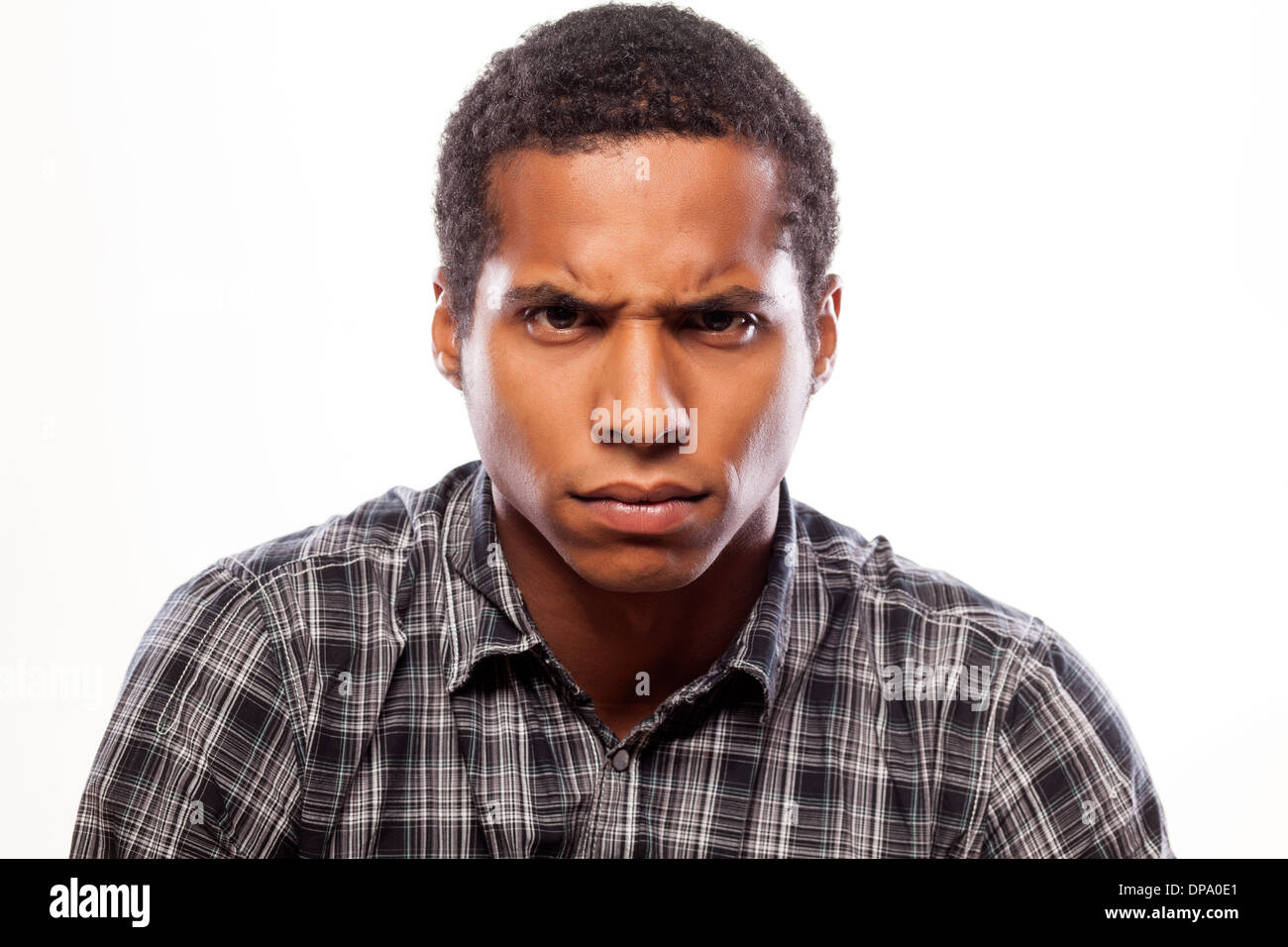 somber dark-skinned young man poses with angry expression Stock Photo ...