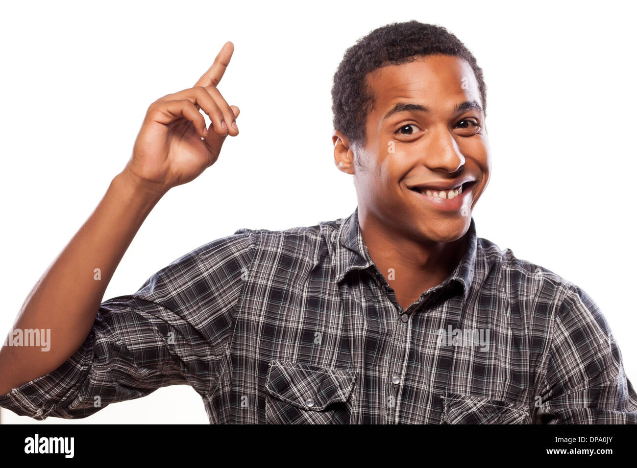 smiling dark-skinned young man pointing a finger upwards Stock Photo ...