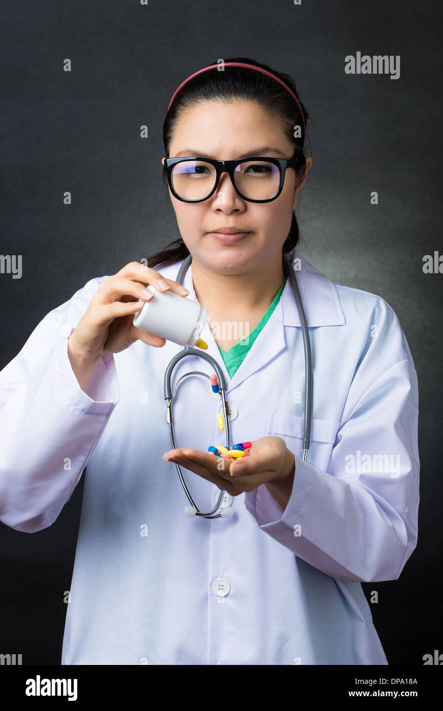 Asian female doctor shooting in studio Stock Photo - Alamy